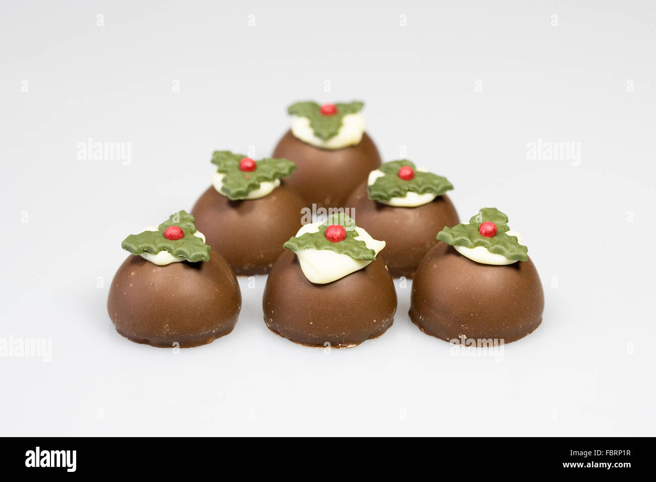 Chocolate christmas puddings on a white background Stock Photo - Alamy