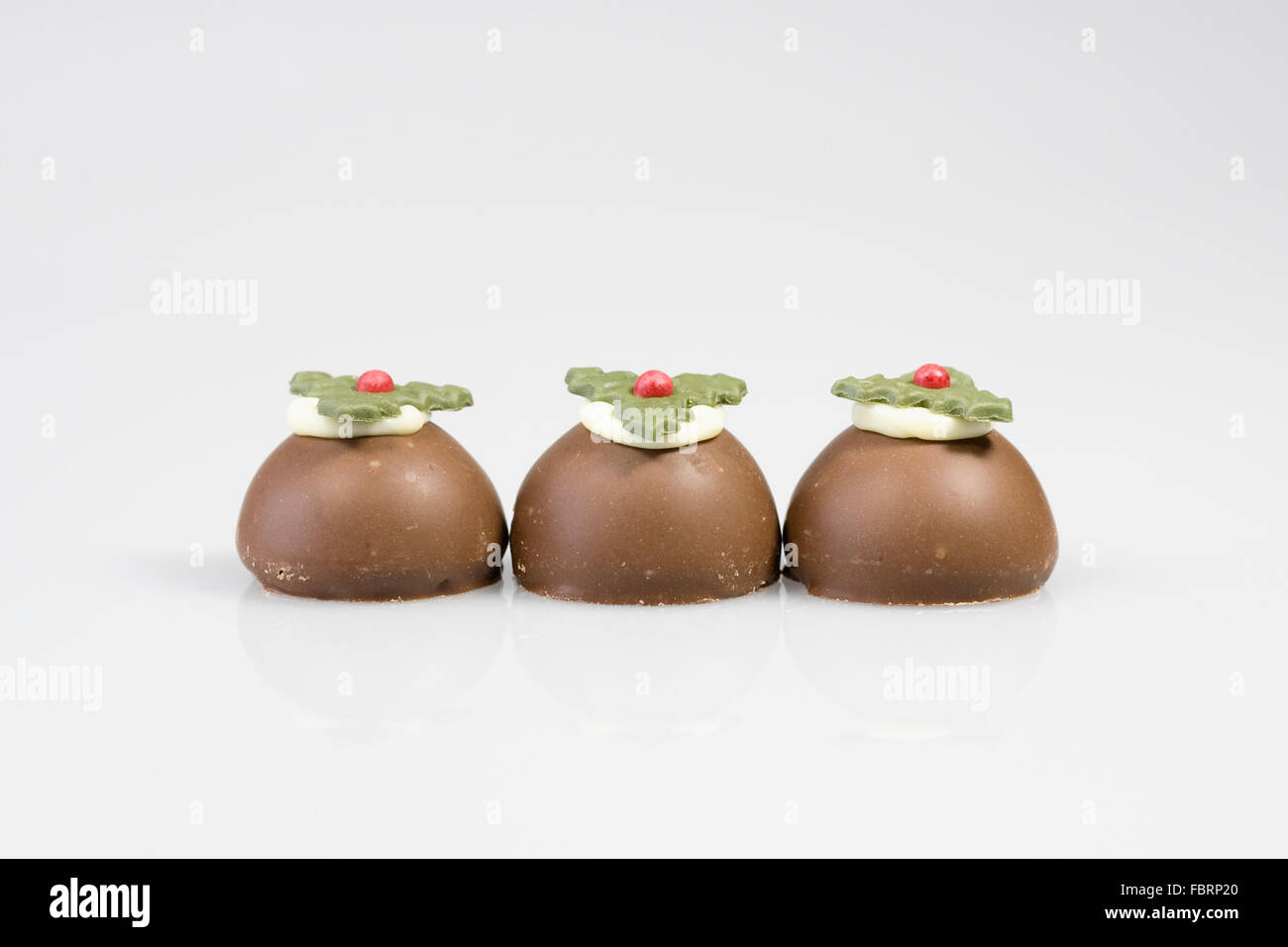 Three chocolate christmas puddings on a white background Stock Photo ...