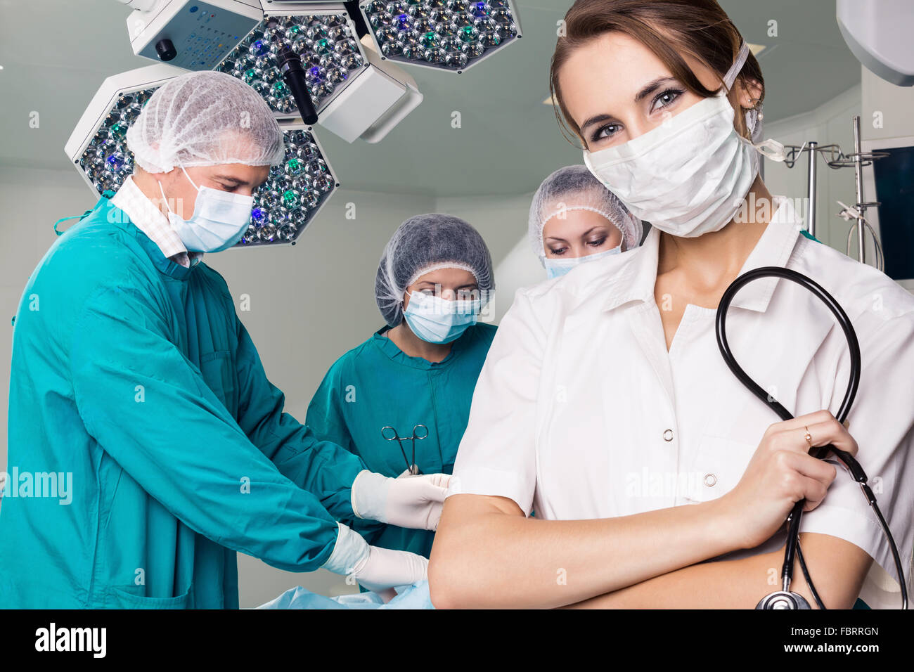 Surgery team operating Stock Photo - Alamy