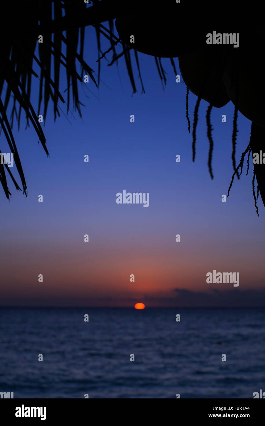 Tranquil beach sunset Stock Photo - Alamy