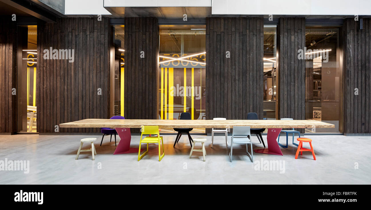 Panoramic elevation of oversize timber table in reception atrium. The ...