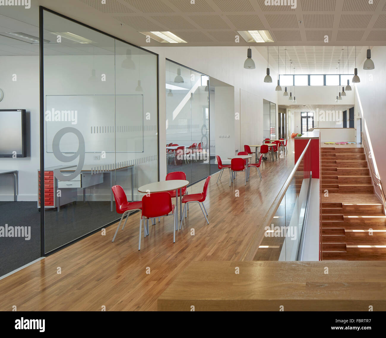 Perspective along first floor open classrooms with feature staircase ...