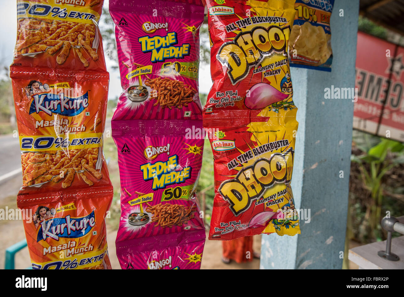Strips of vibrant and appealing packets of dried savory snacks are ...