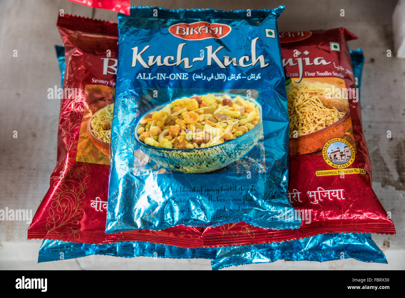 Strips of vibrant and appealing packets of dried savory snacks are ...