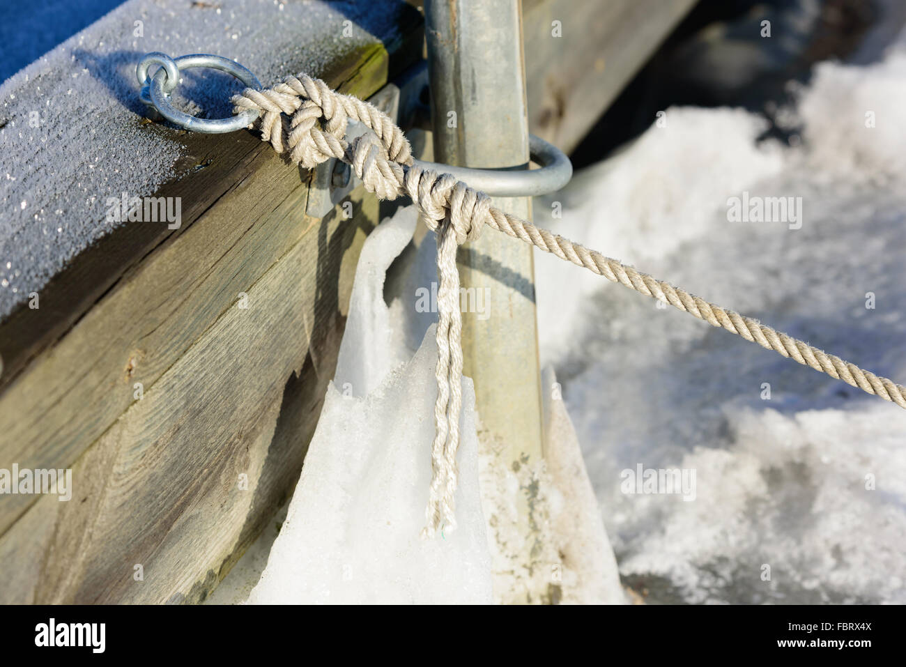 Close up of white rope tied to a pier in winter Stock Photo - Alamy
