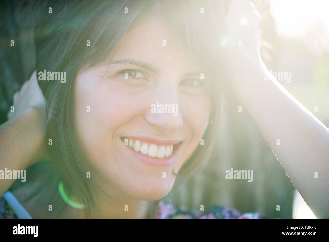 Woman smiling cheerfully outdoors, portrait Stock Photo - Alamy