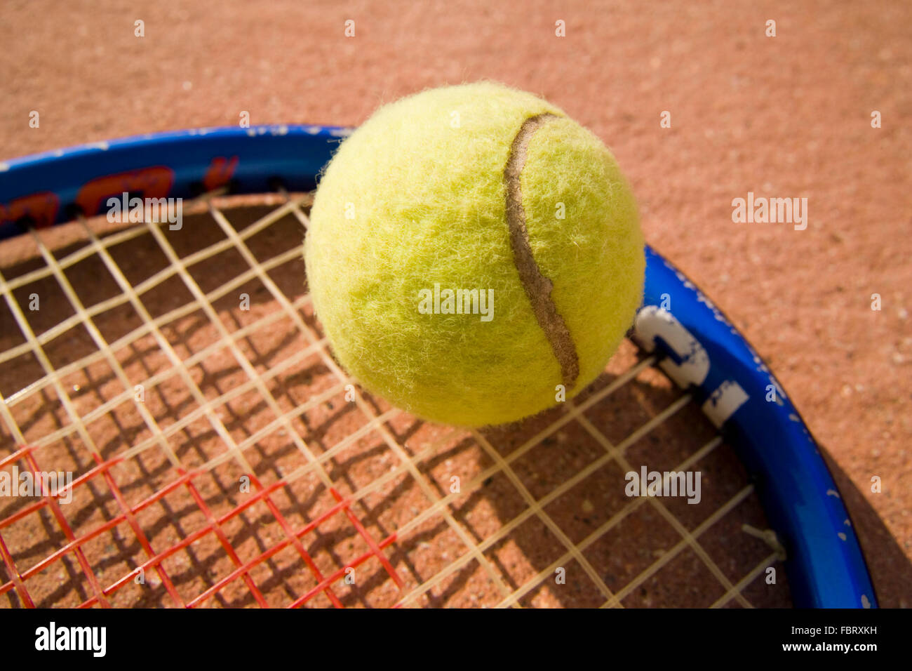Tennis ball on racket Stock Photo - Alamy