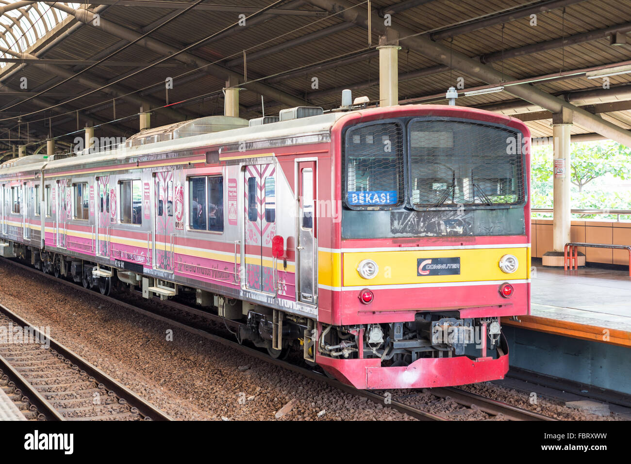 Commuter train stopped at a station in Jakarta, Indonesia Stock Photo ...