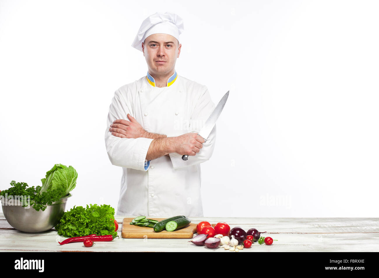 Chef posing with knife in his kitchen Stock Photo - Alamy