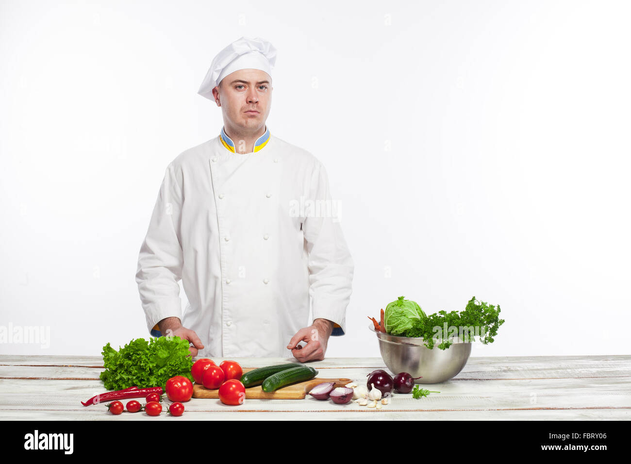 Chef cutting a green cucumber in his kitchen Stock Photo - Alamy