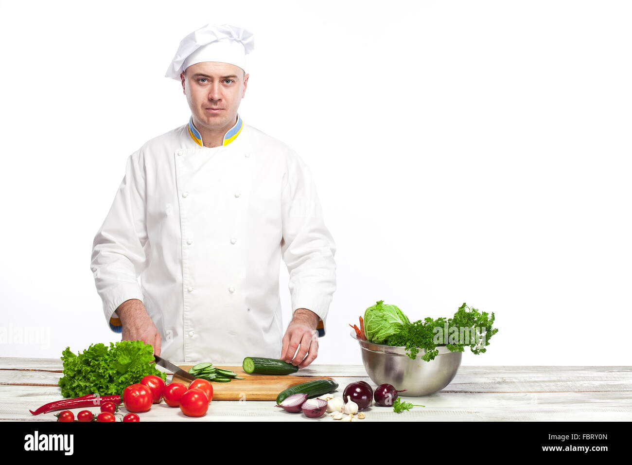 Chef cutting a green cucumber in his kitchen Stock Photo - Alamy