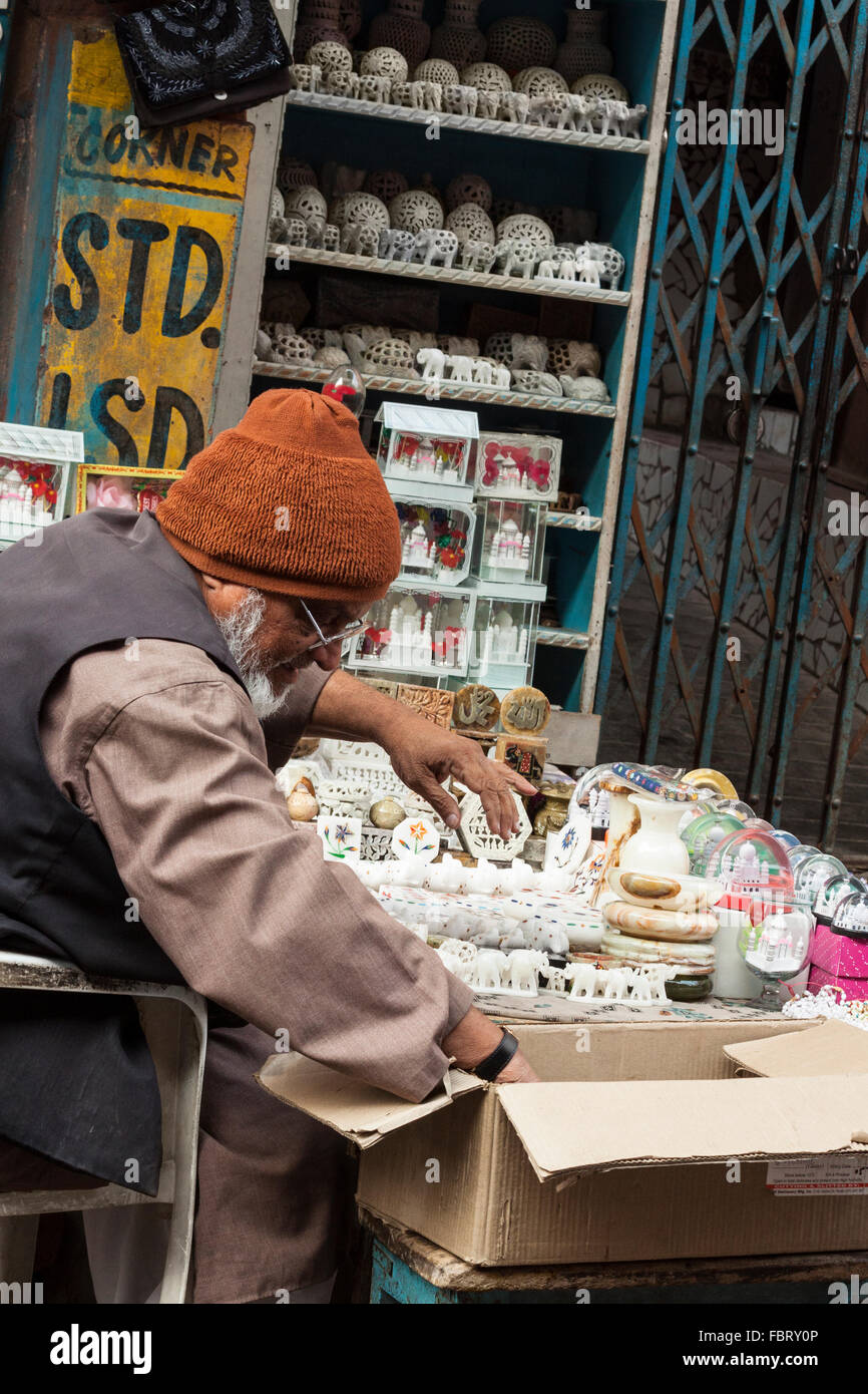 An Indian merchant selling souvenirs in front of Taj Mahal mausoleum ...