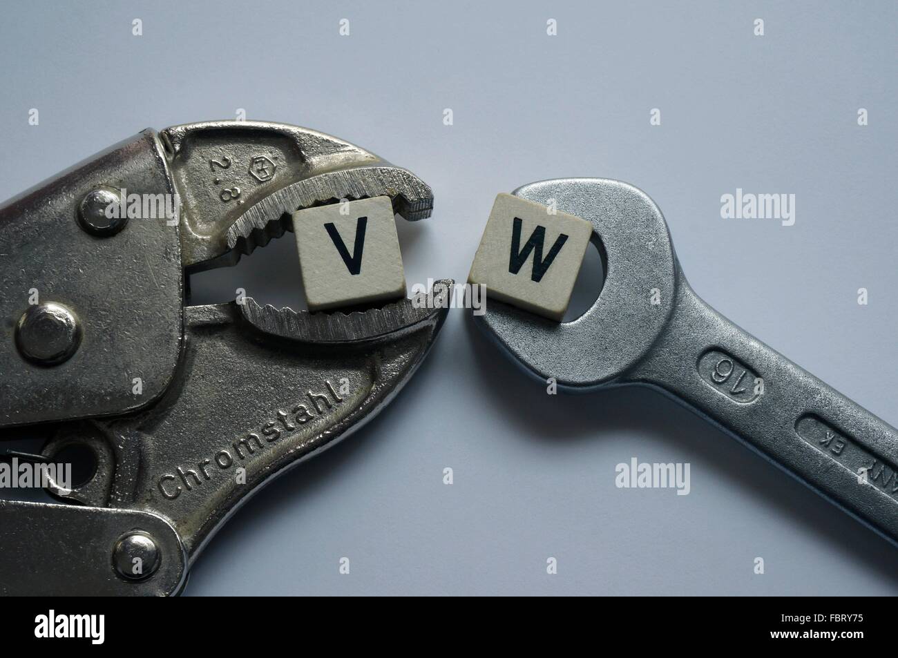 Letter cubes with the inscription 'VW' in a plier head and a wrench ...