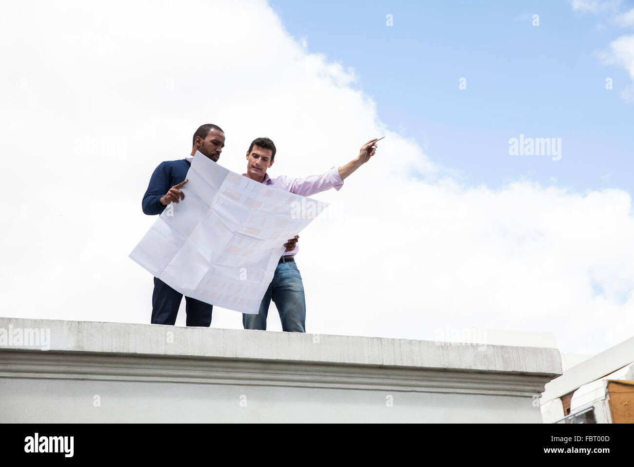 Engineer showing colleague development plan Stock Photo - Alamy