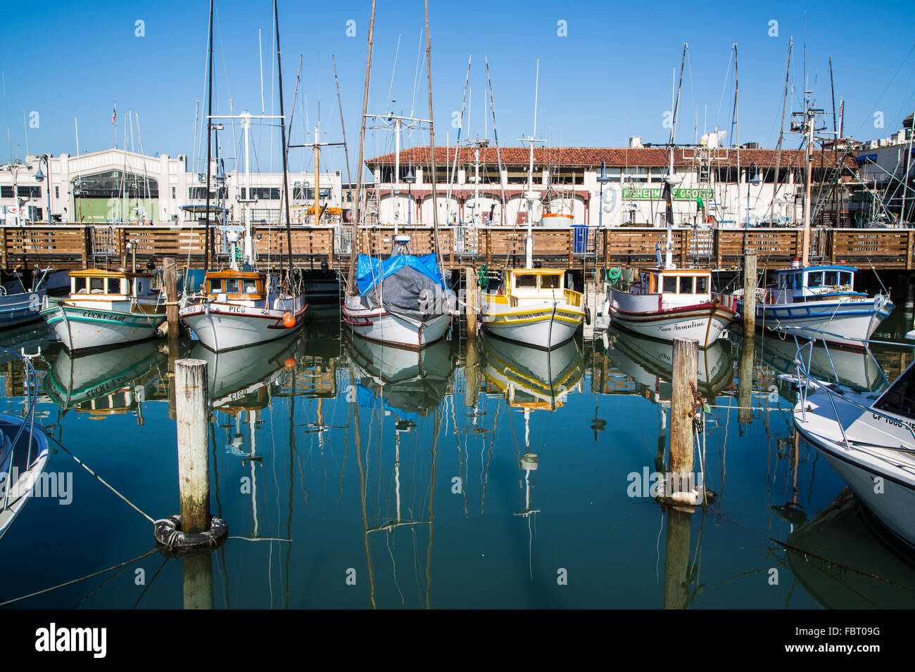 Reflections of boats in the marina in Fisherman's Wharf, San Francisco ...