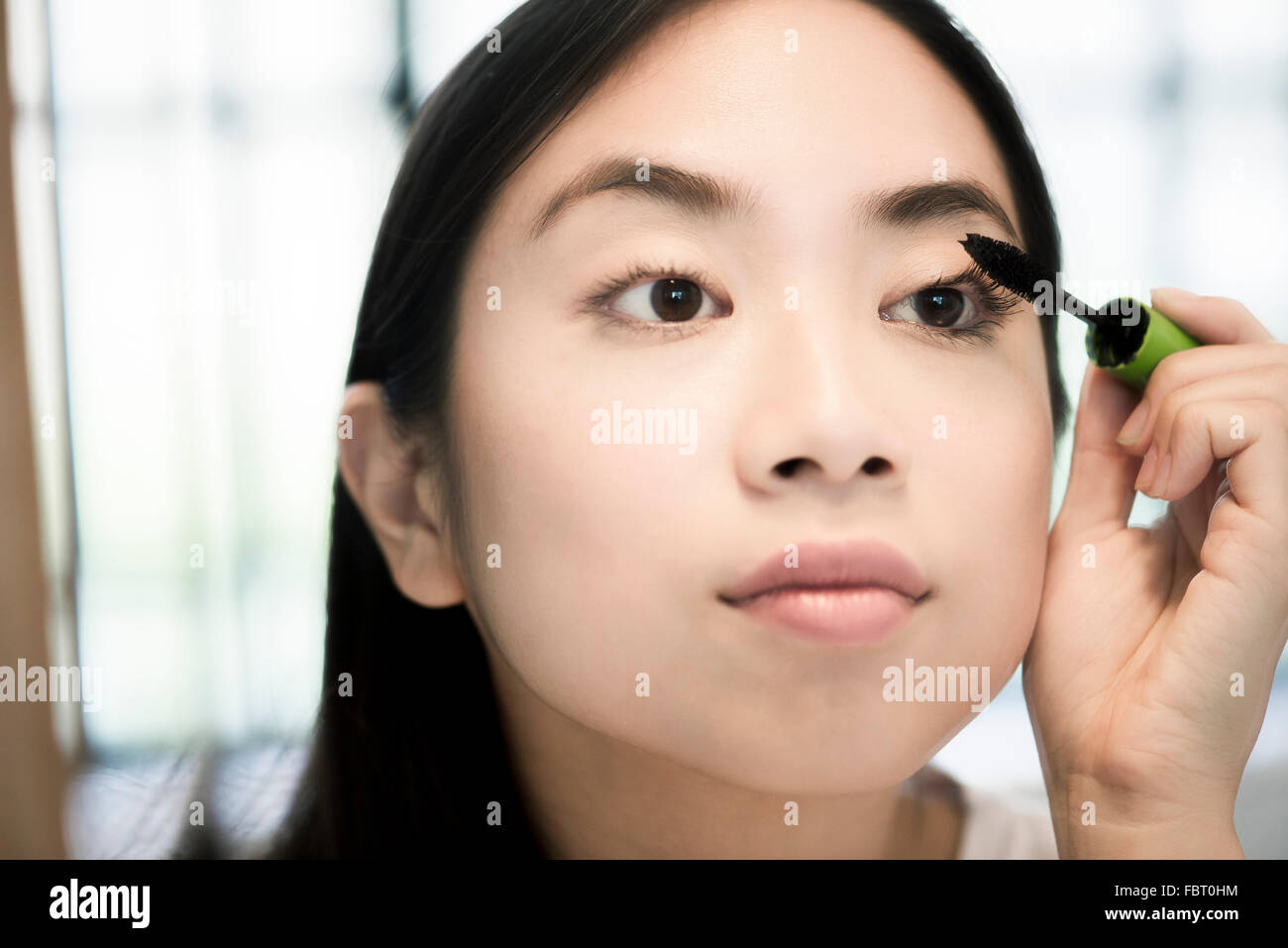 Woman applying mascara Stock Photo - Alamy