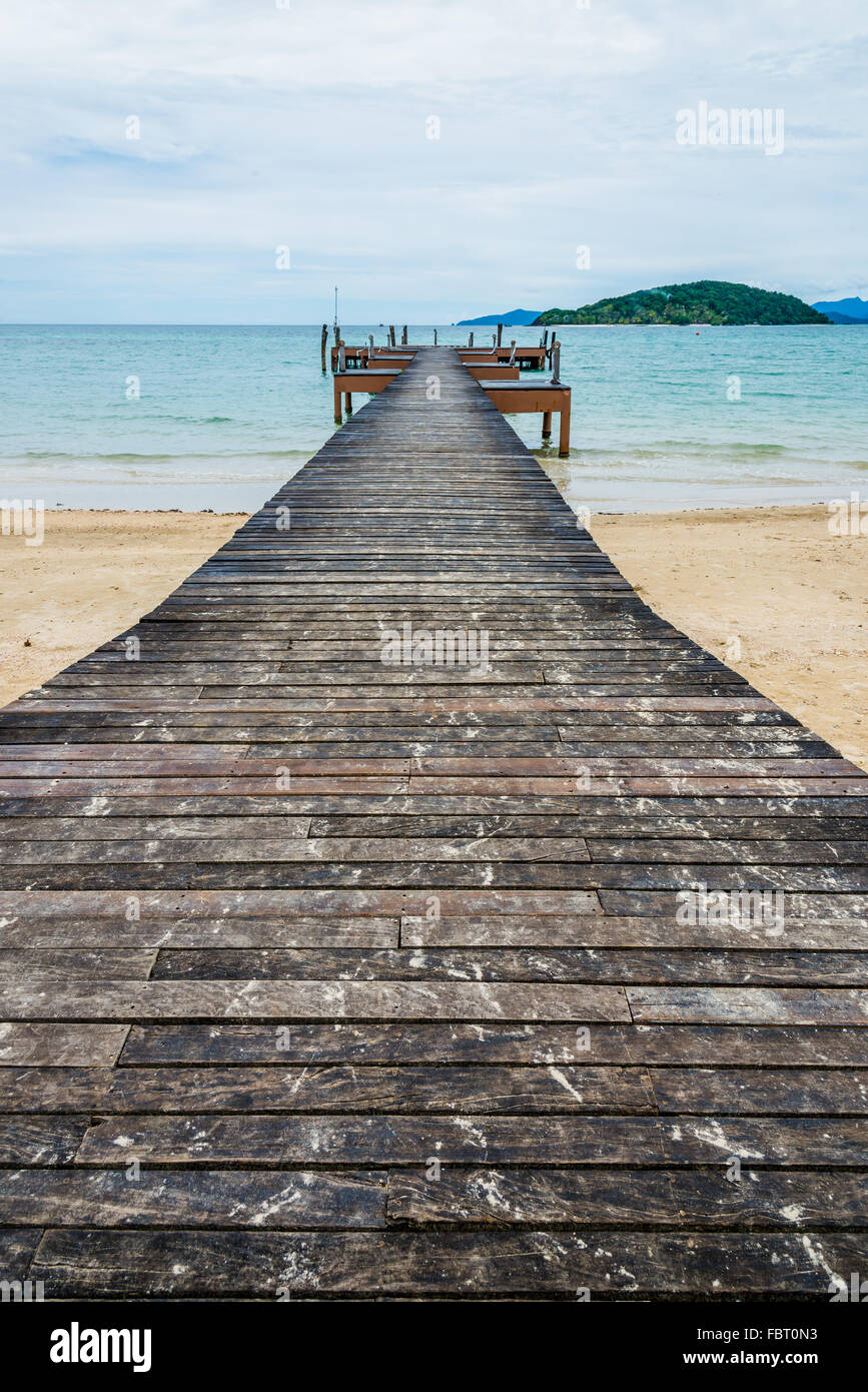 Long wood bridge on the beach in Kohmak island, Thailand Stock Photo ...