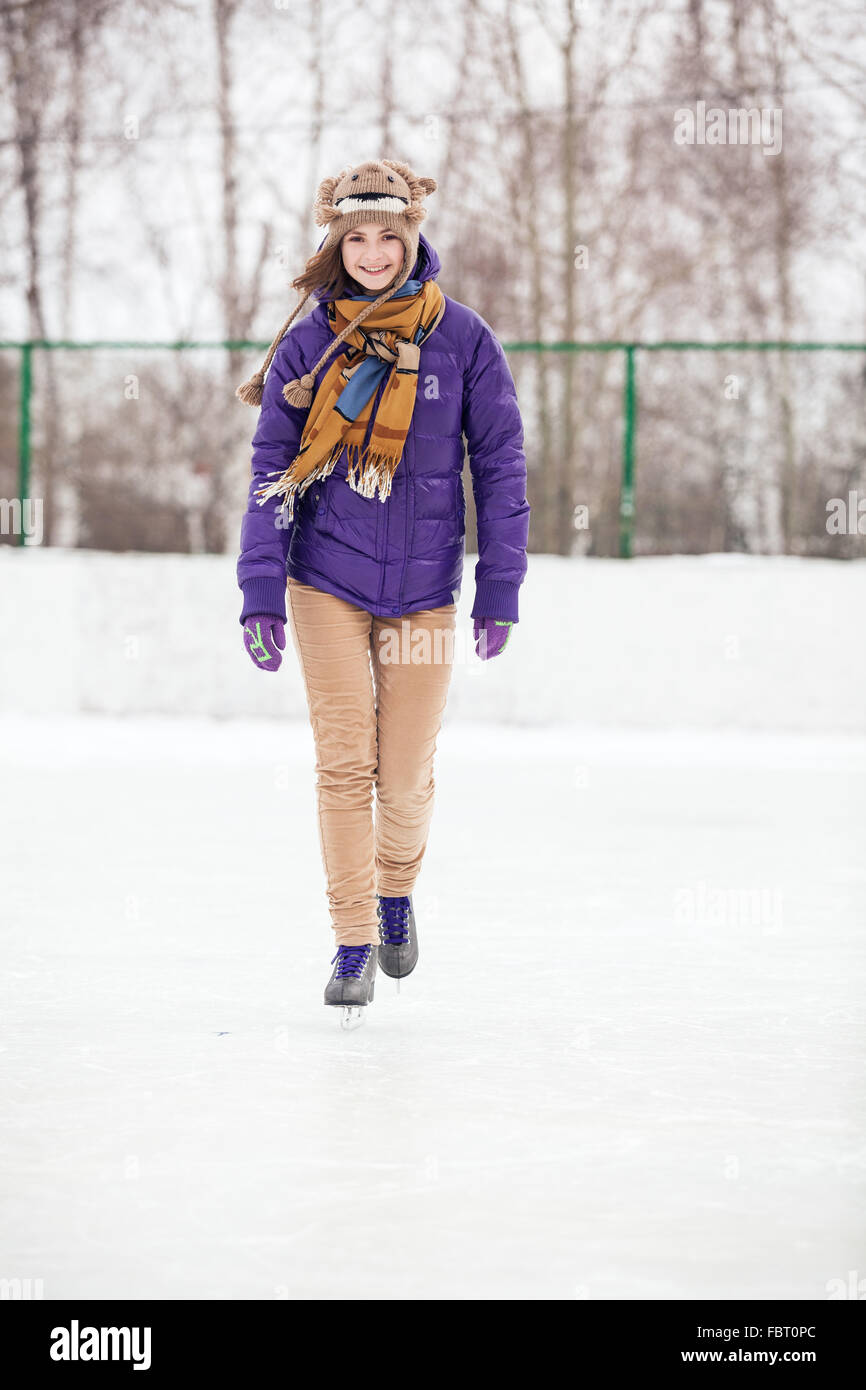 Young woman skating on ice with figure skates Stock Photo - Alamy