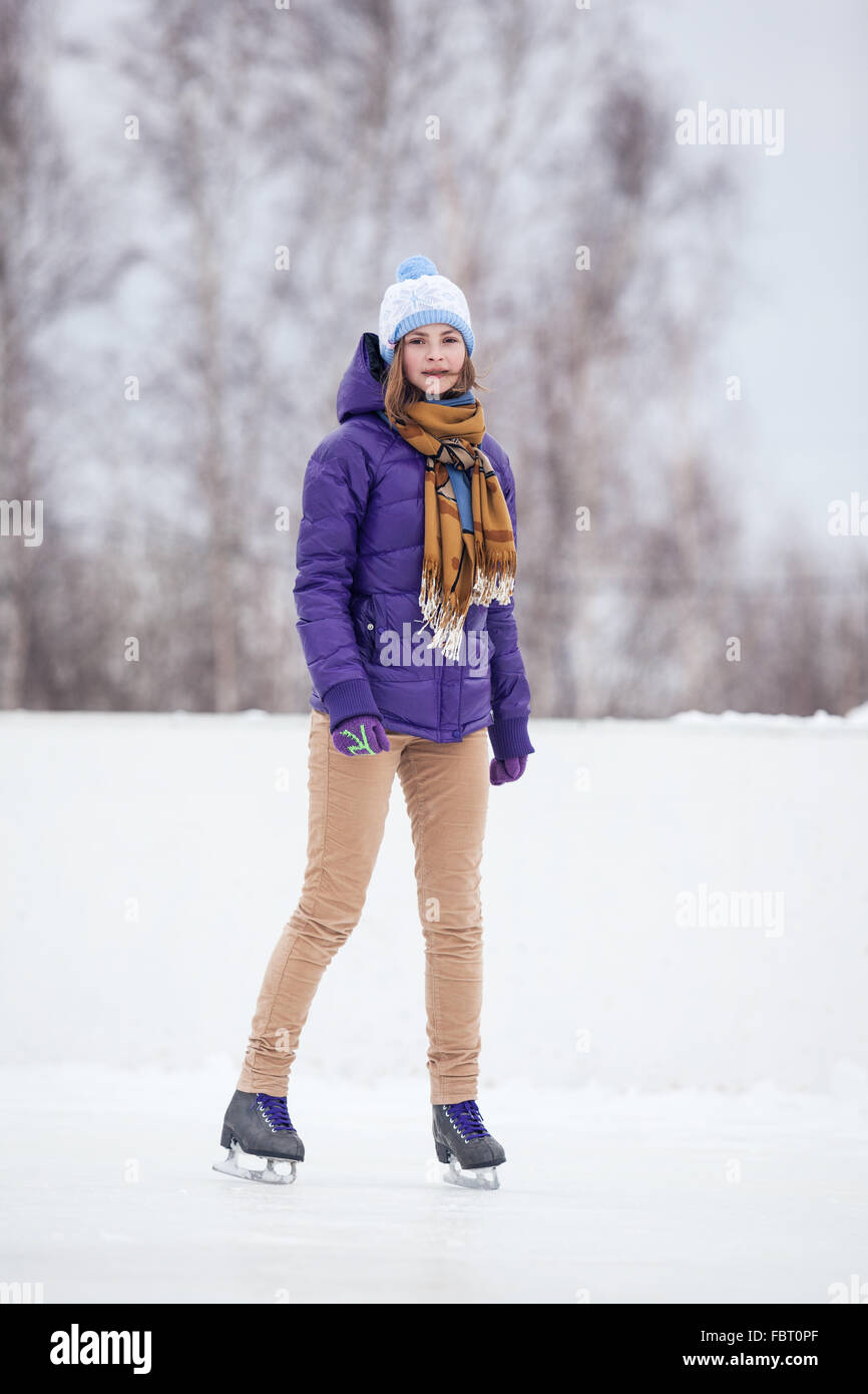 Young woman skating on ice with figure skates Stock Photo - Alamy