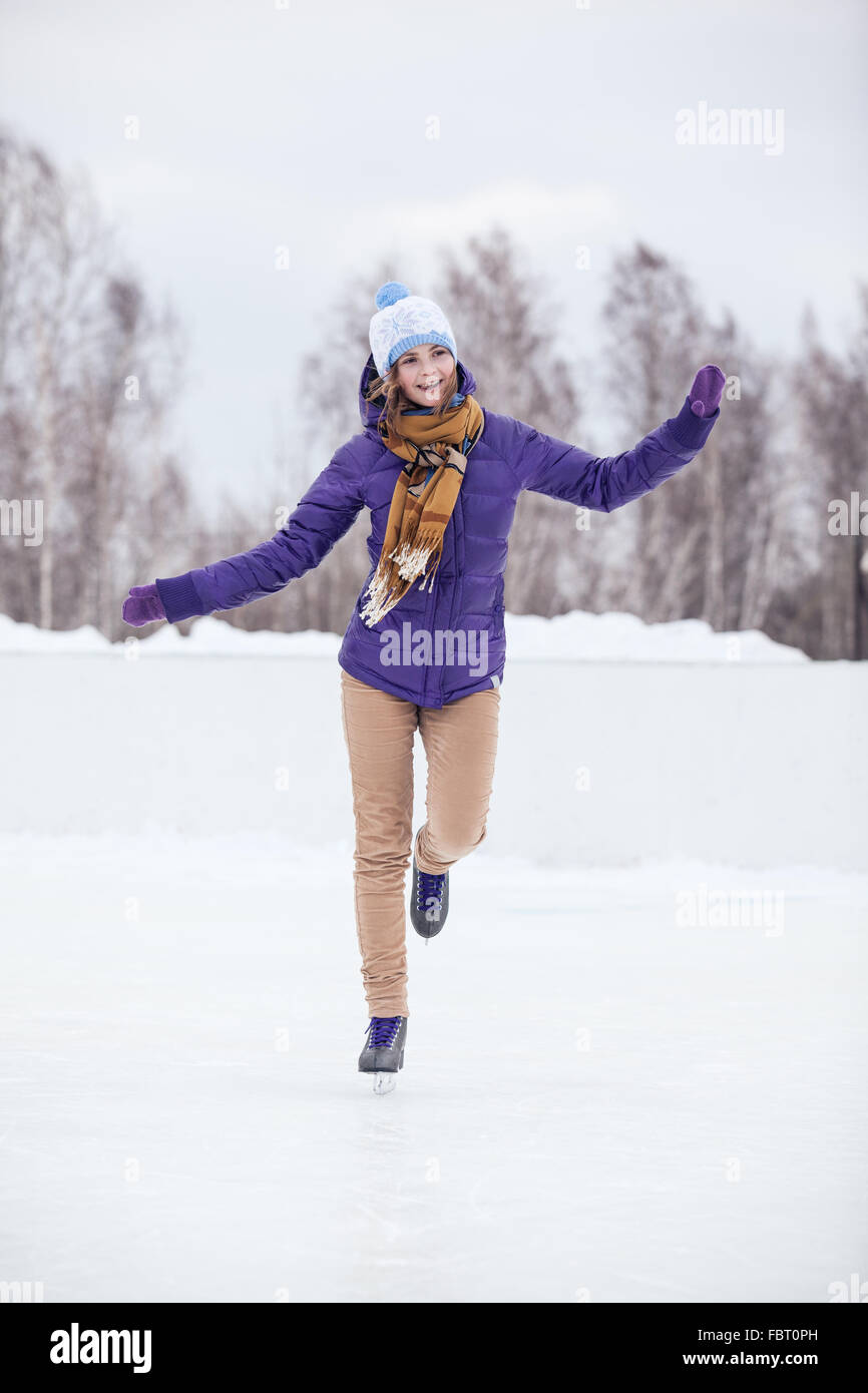Young woman skating on ice with figure skates Stock Photo - Alamy