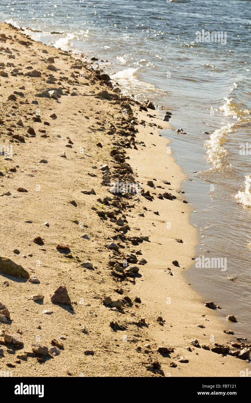 sandy shore with calm sea Stock Photo - Alamy