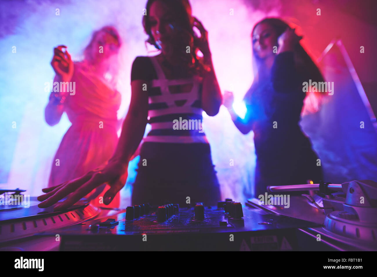 Pretty dj girl standing by turntables Stock Photo - Alamy