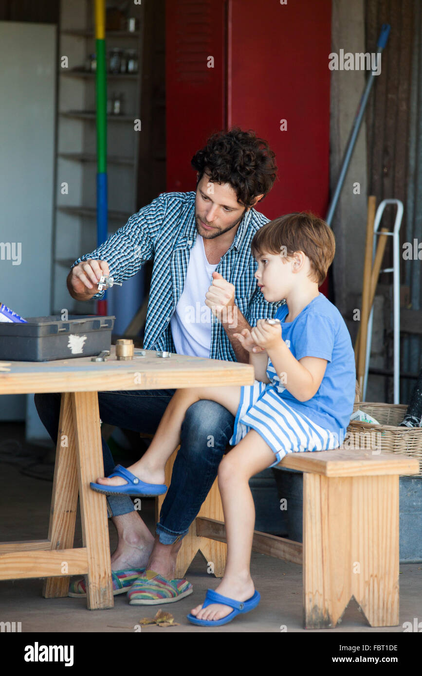 Child helping his father sort work materials Stock Photo - Alamy