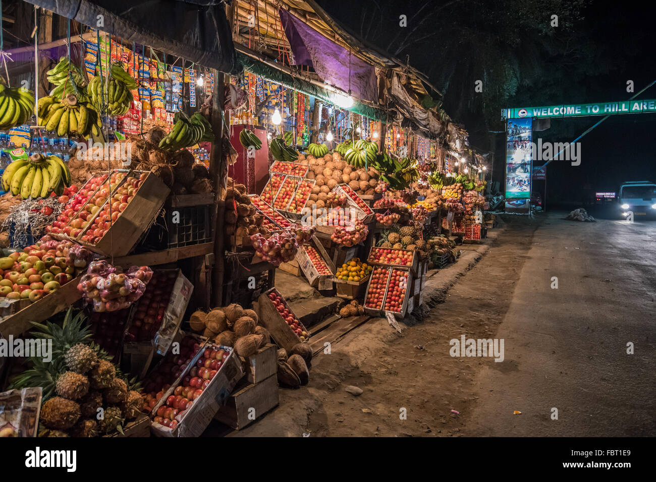 Indian market. Bright red apples. A night market selling a wide variety ...