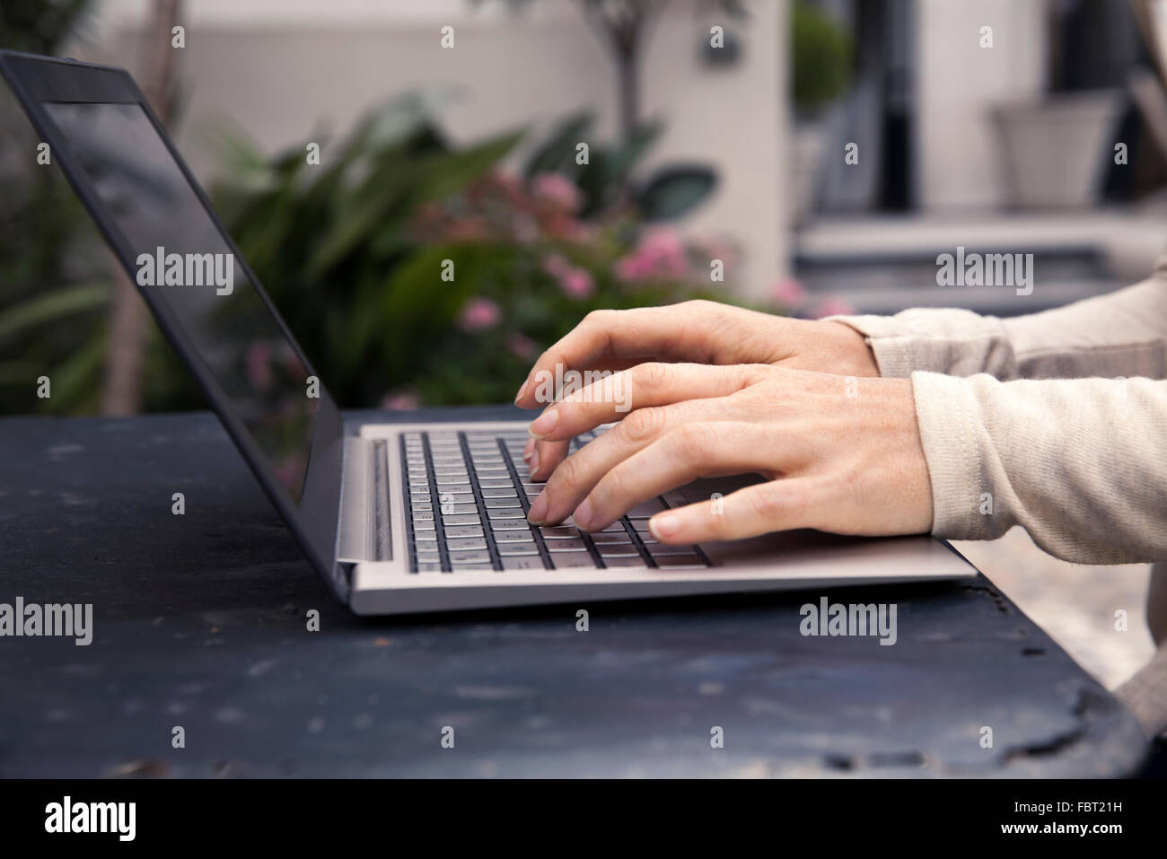 Using laptop outdoors Stock Photo - Alamy