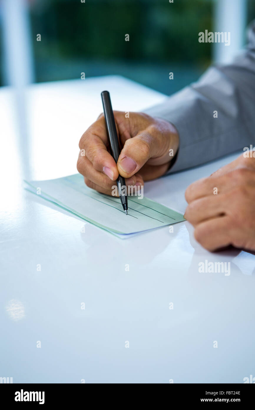 Businessman writing on paper Stock Photo - Alamy
