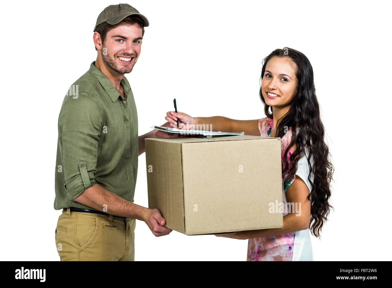 Woman signing for pack delivery with smiling postman Stock Photo - Alamy