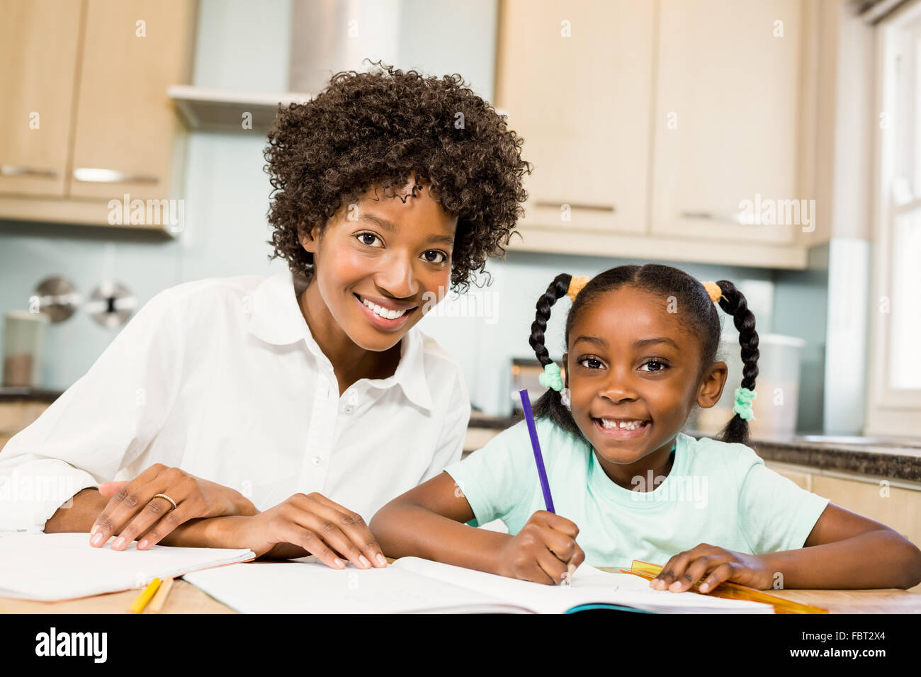 Mother checking daughters homework Stock Photo - Alamy