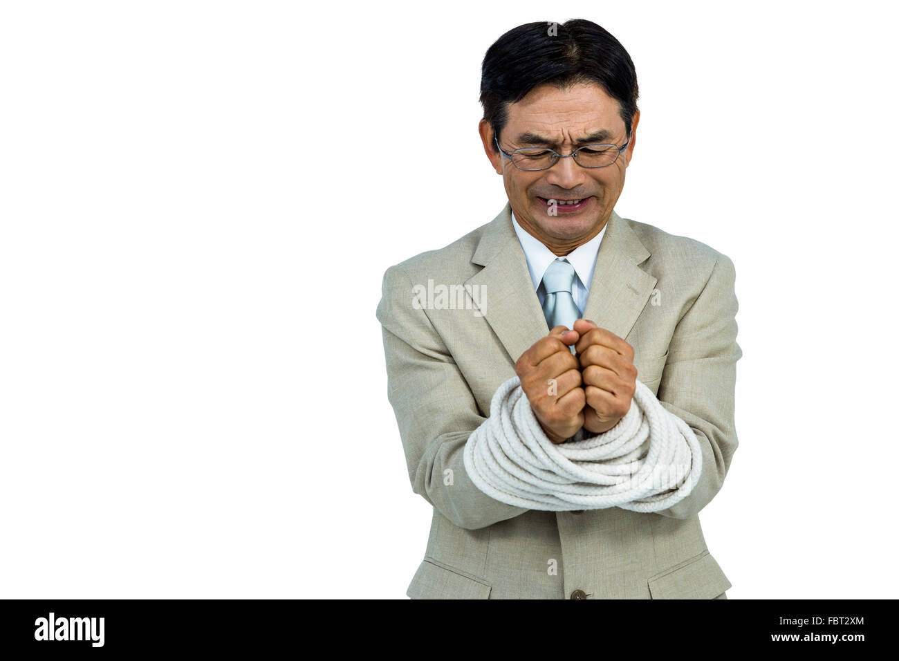 Asian businessman tied up in rope Stock Photo - Alamy
