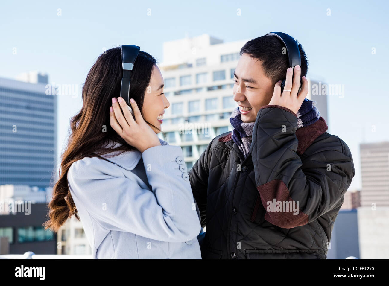 Young couple wearing headphones hi-res stock photography and images - Alamy