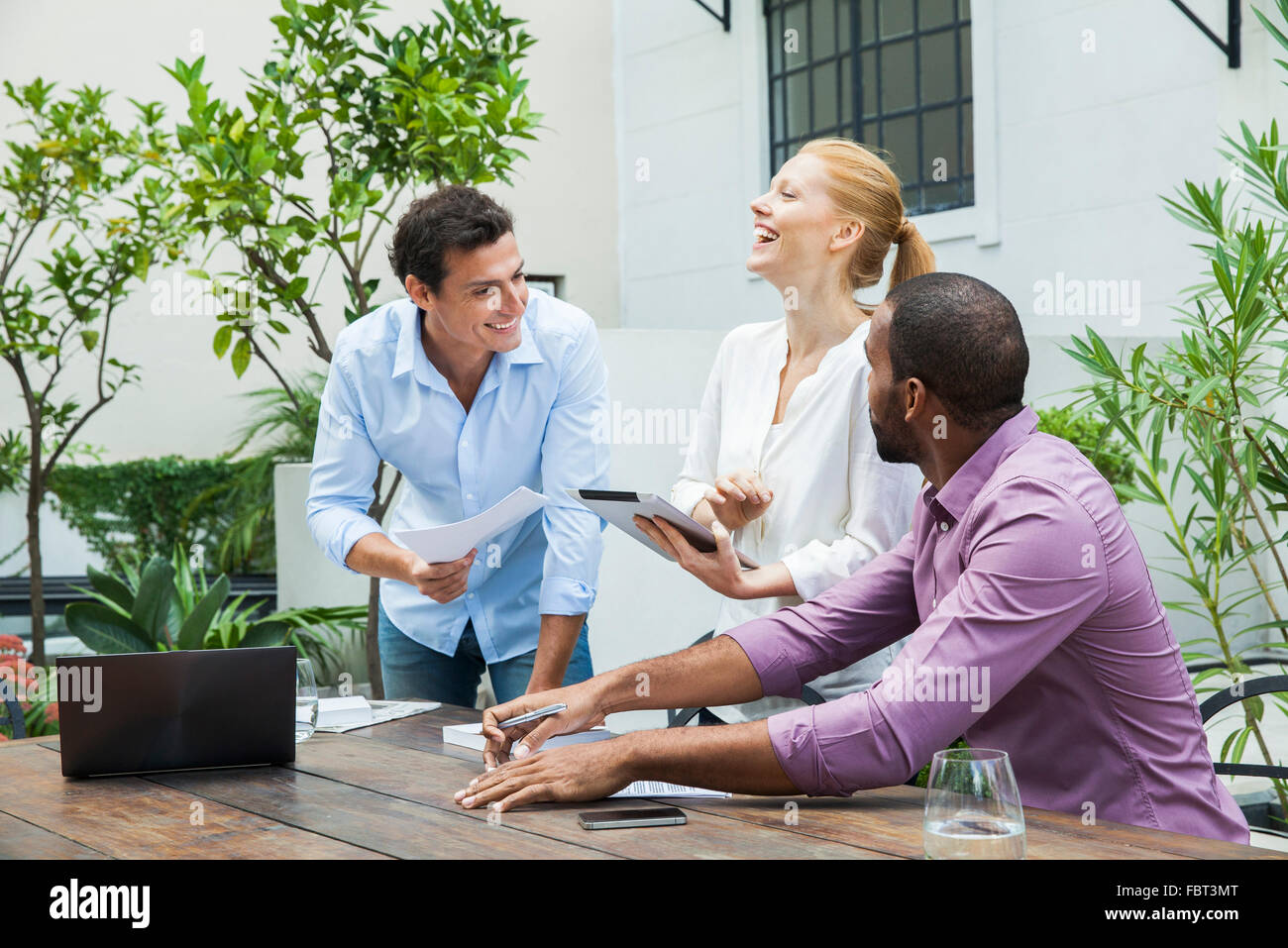 Business professionals having fun working together Stock Photo - Alamy