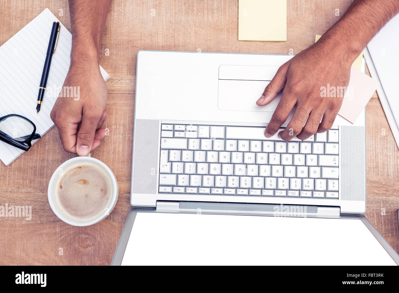 Businessman holding coffee typing on hi-res stock photography and ...