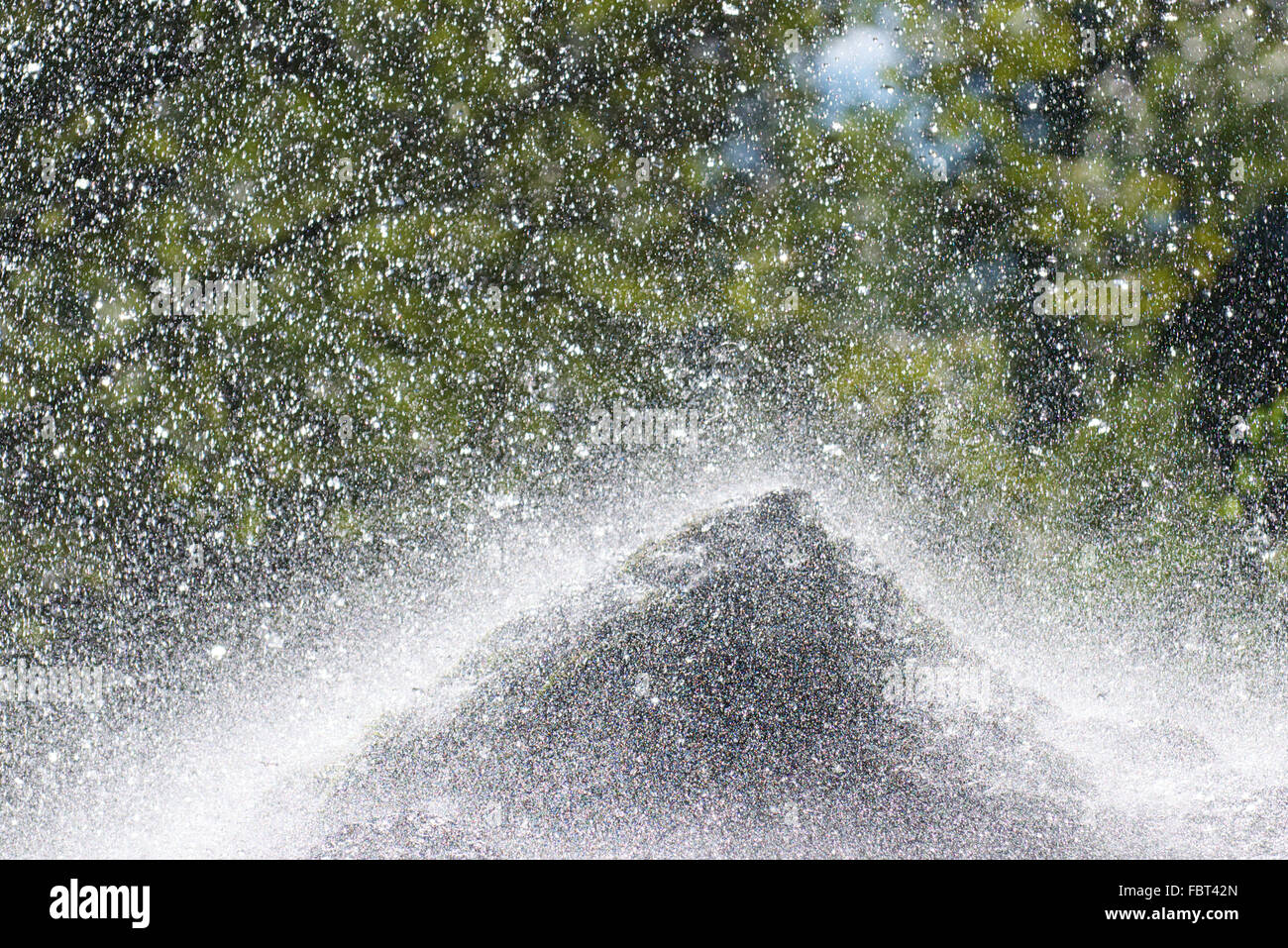 Water splashing over rock Stock Photo - Alamy