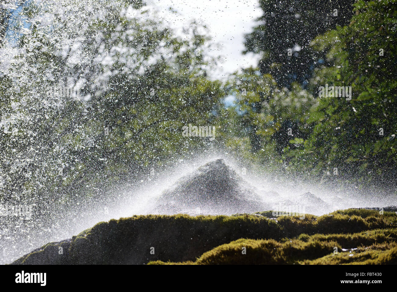 Water splashing over rock Stock Photo - Alamy