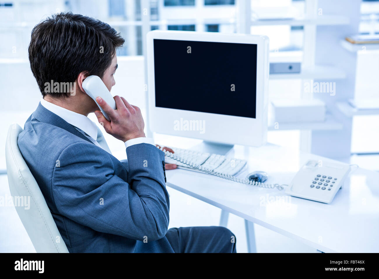 Businessman using his telephone Stock Photo - Alamy