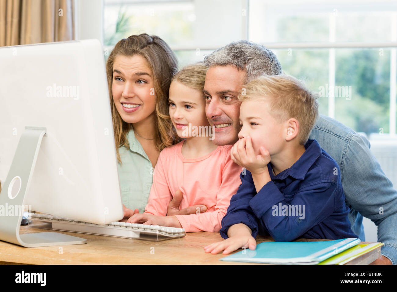 Happy family using the computer Stock Photo - Alamy