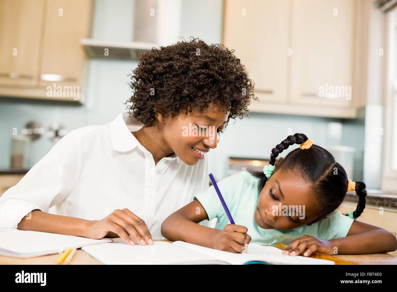 Mother checking daughters homework Stock Photo - Alamy