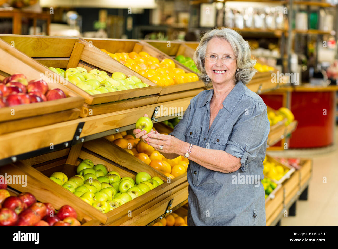 Smiling senior woman picking apple Stock Photo - Alamy