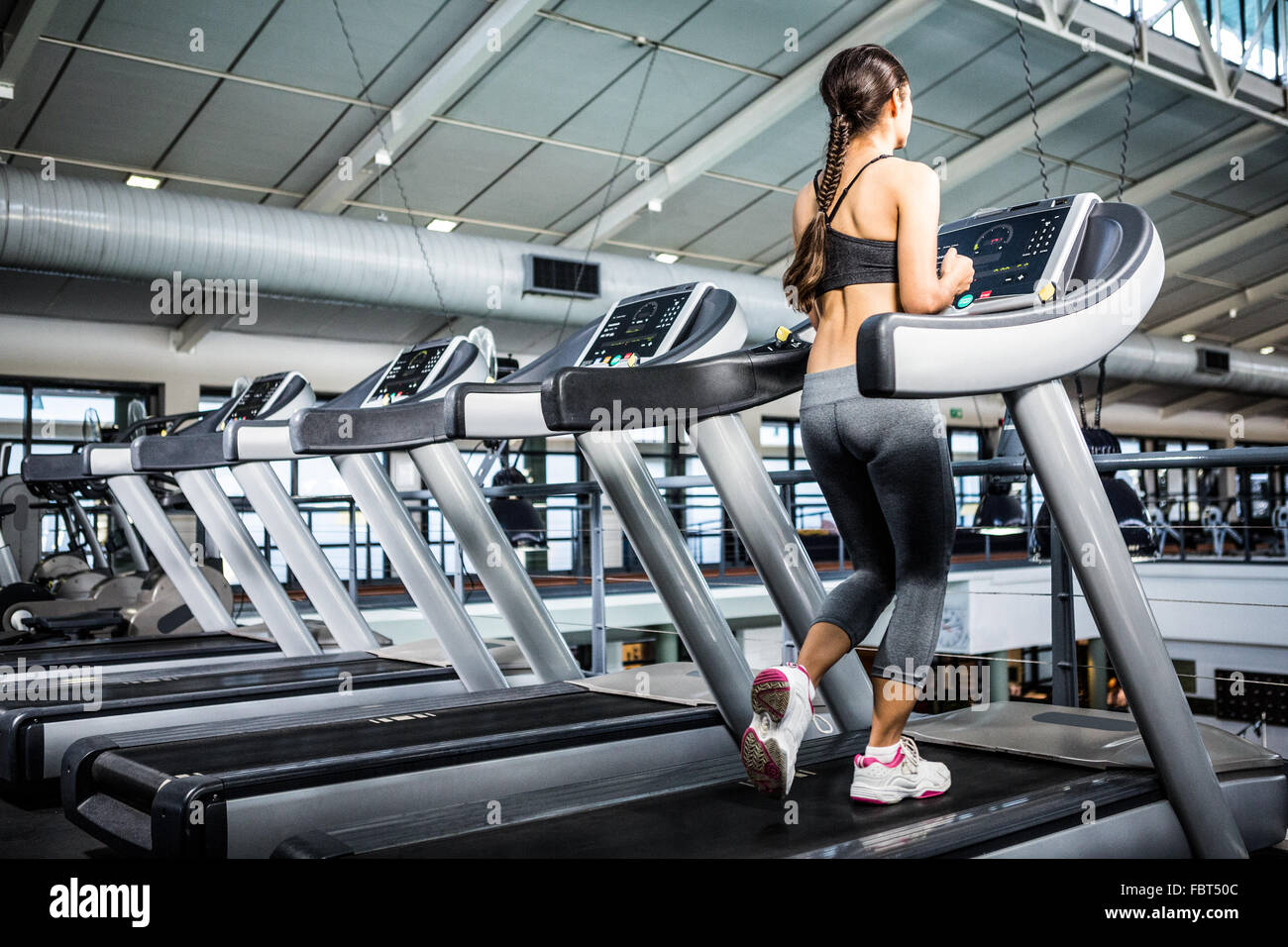 Rear view of woman jogging in treadmill Stock Photo - Alamy