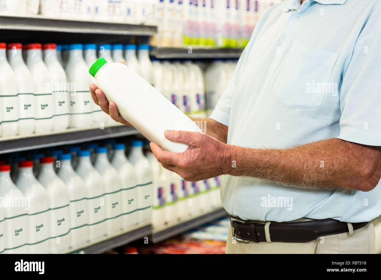 Senior man buying milk Stock Photo - Alamy
