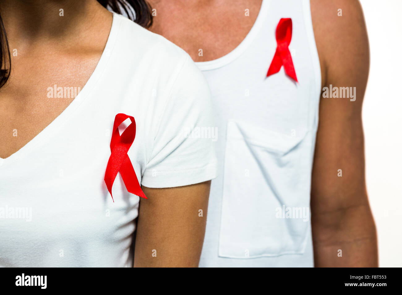 Midsection of people with red ribbon on clothes Stock Photo - Alamy
