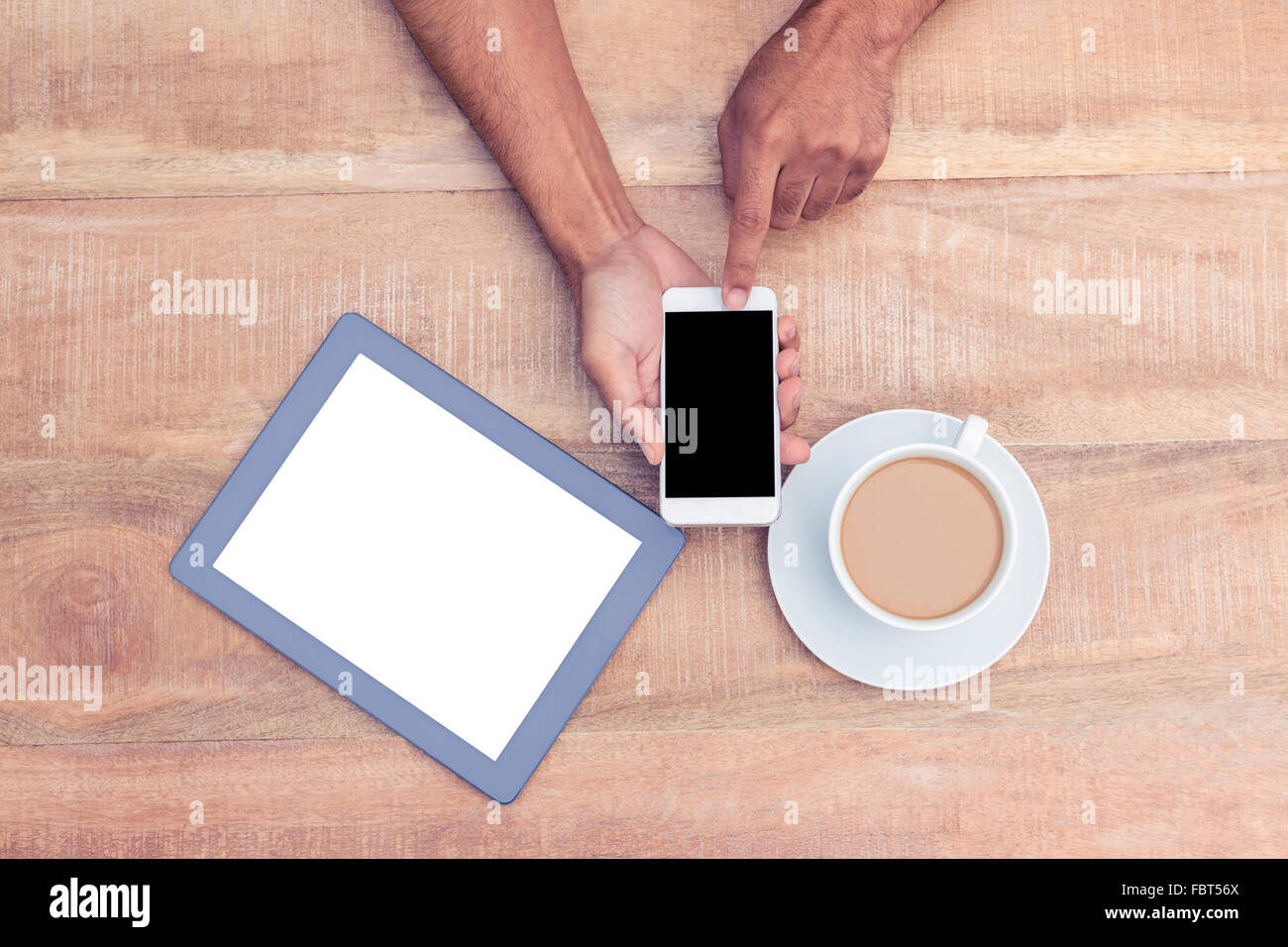Person using smart phone by coffee and tablet Stock Photo - Alamy