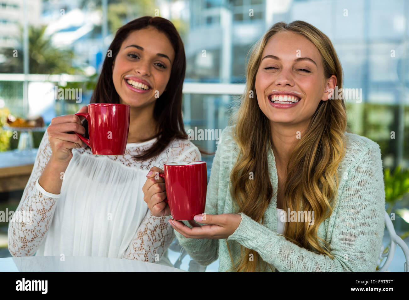 two girls drink tea Stock Photo - Alamy