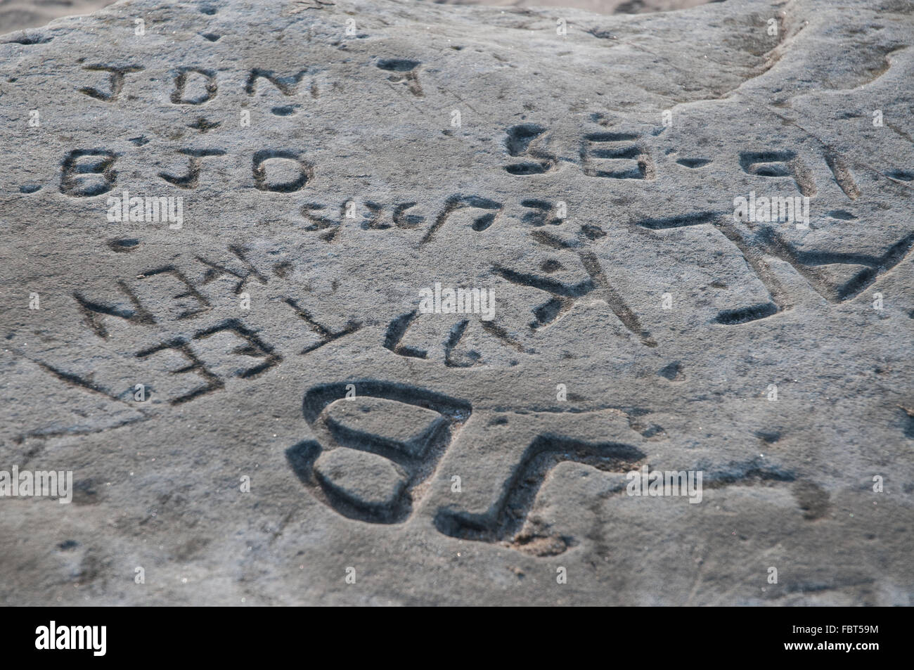 Initials carved into sandstone rock Stock Photo - Alamy
