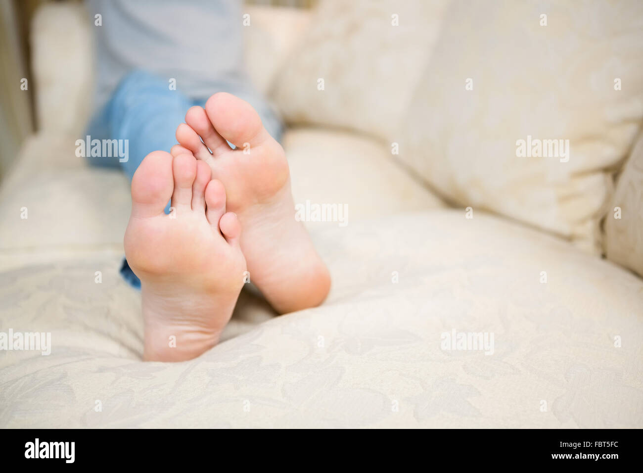 Woman sitting on couch feet hi-res stock photography and images - Alamy