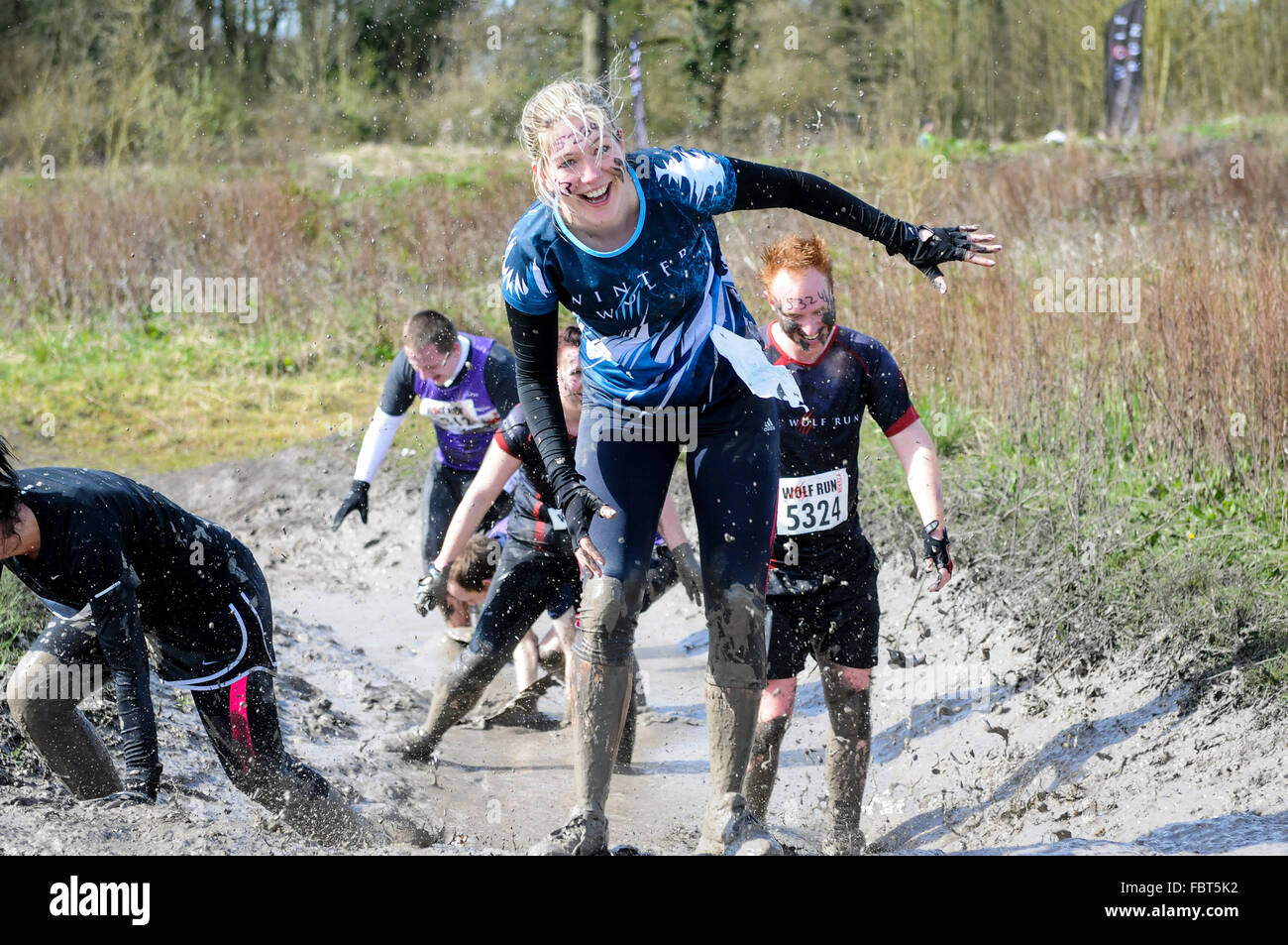 Female runner stuck in mud at obstacle course race, UK Stock Photo - Alamy